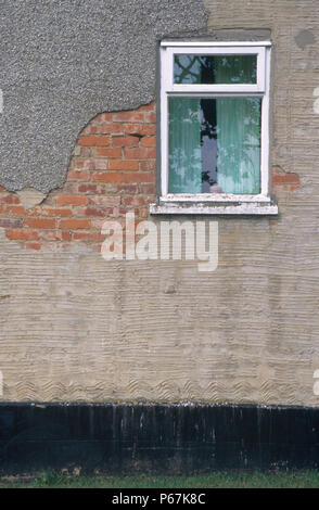 Derelict council house in poor housing estate slum with many social ...