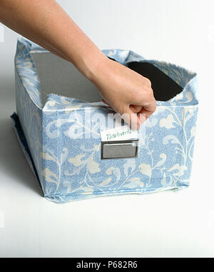 Covering a cardboard storage box Stock Photo - Alamy