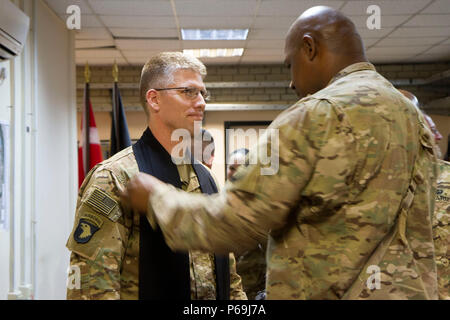Division Chaplain (Lt. Col.) David Bowlus hugs his son Andrew, while ...