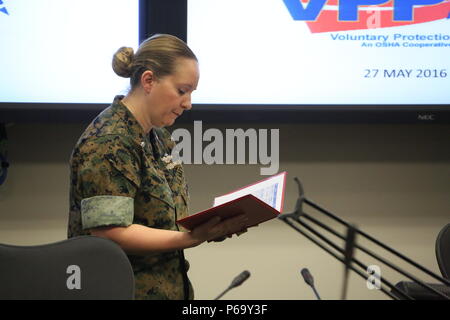 Navy Cmdr. Amy Varney recites an award during a Voluntary Protection ...