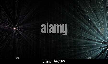 Light rays through small holes in a dark metal space Stock Photo - Alamy