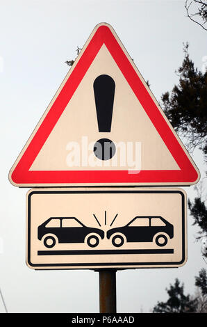 High risk of collision. A road sign with an exclamation point and two ...