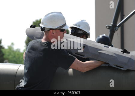 An Airman with the 7th Munitions Squadron installs a fuse protection ...