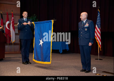 A member of the Honor Guard unfurls the general officer flag being ...