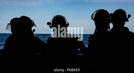 Sailors standby on the fantail of the aircraft carrier USS Dwight D ...