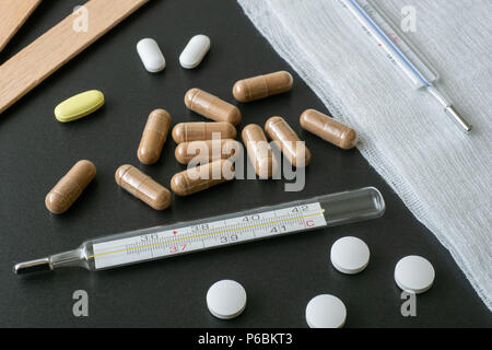 Traditional medical thermometer for measuring body temperature. Pills ...