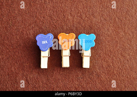 Three plus six on a brown background Stock Photo - Alamy