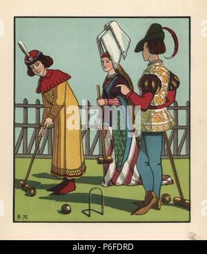 Medieval men and woman playing a game of croquet with mallet and hoops ...