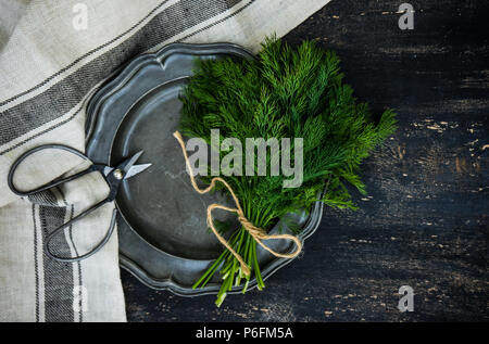 Organic food concept with bunch of dill or fennel on vintage plate ...