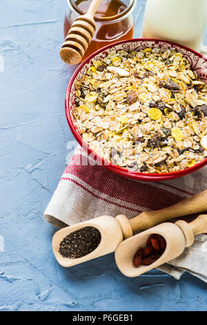 Healthy brekfast concept with oatmeal, superfood, honey and milk on ...