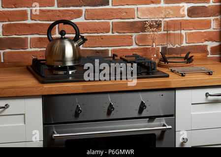 Modern kitchen with exposed brick wall and peninsula unit, Hong Kong ...