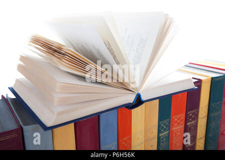 stack of colored books on white desk closeup Stock Photo - Alamy