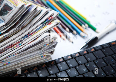 stack of newspapers and calendar close-up on white Stock Photo - Alamy