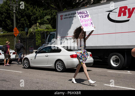 A drag queen walks through traffic in downtown Los Angeles, during the ...