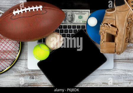 Sports equipment with computer and money for betting concept Stock ...