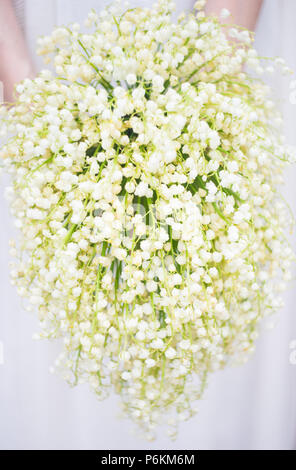 Beautiful may lilies in bride bunch on rustic background with copy ...