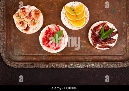 Snack with rice crispbread and fresh fruits on metal tray brown ...