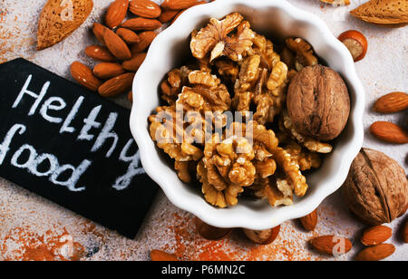Mix nuts on beton background. Cut nuts Stock Photo - Alamy