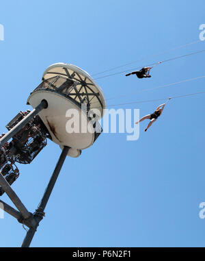 People zip line from Bournemouth pier towards Bournemouth Beach in ...