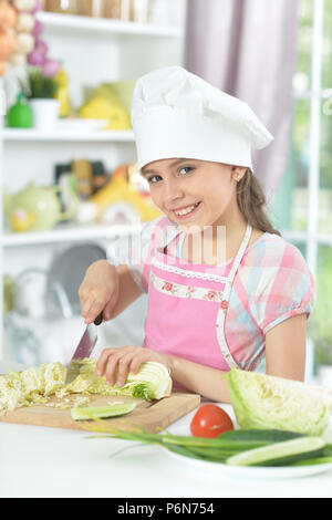Cute little girl making dinner Stock Photo - Alamy