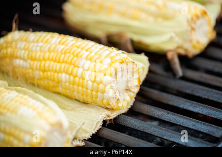 Step by step. Grilling fresh corn on outdoor gas grill Stock Photo - Alamy