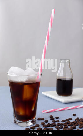 Cold brew coffee in a bottle with transparent glass full of ice on ...