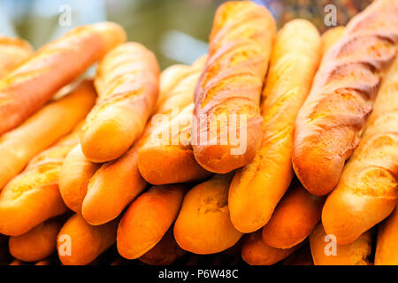 French bread, French sticks, baquettes, freshly baked, stacked two to ...