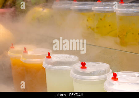 Section of freshly prepared juices from tropical fruits Stock Photo - Alamy