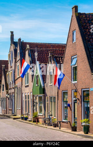 At home with national flags on the street of old Riga in the holiday by ...