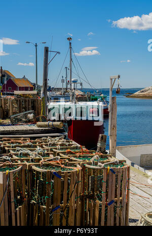 Commercial fishing wharf with lobster traps and lobster boats at ...