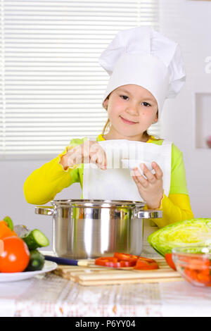 Happy female chef wearing uniform and cap on light grey background ...