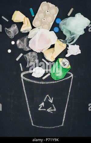 Different plastic garbage falling into trash bin. Waste management and ...