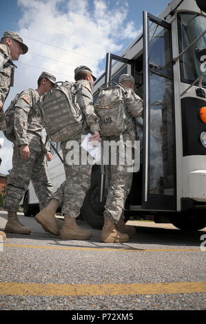 U.S. Army flight school students at Fort Rucker, Ala. load up a bus ...