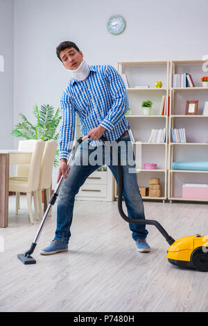 Injured man with neck injury vacuum cleaning house Stock Photo - Alamy