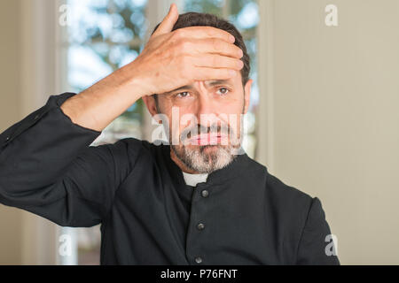 Senior priest religion man stressed with hand on head, shocked with ...