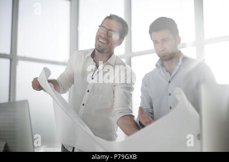 employees discussing drawings for new project Stock Photo - Alamy
