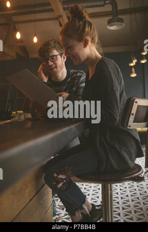smiling couple with menu at restaurant Stock Photo - Alamy