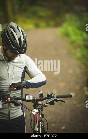 Cyclist with smartwatch Stock Photo - Alamy