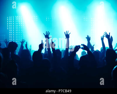 Crowd at concert - Cheering crowd in bright colorful stage lights Stock ...