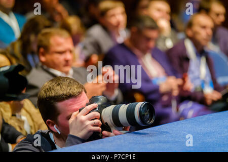 Professional photographer works at business conference Stock Photo - Alamy