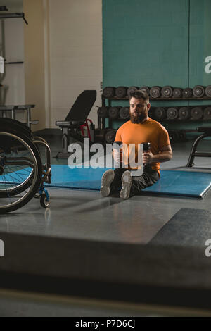 Handicapped man exercising with dumbbell Stock Photo - Alamy