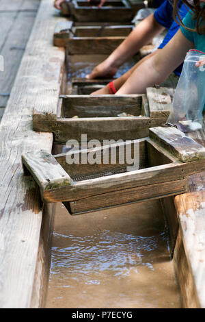 Gemstone panning with a sluice box. Sifting for stones and fossils at ...