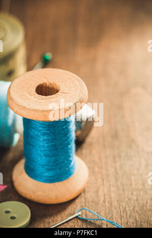 Retro sewing accessories on blue wooden background Stock Photo - Alamy