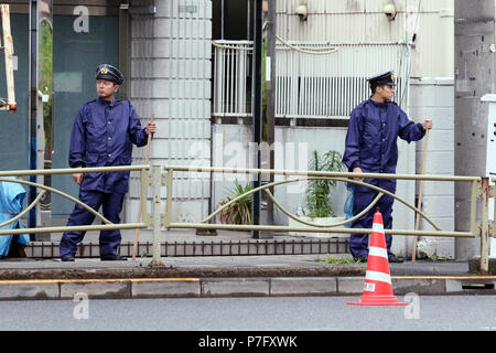Tokyo, Japan. 6th July, 2018. Police officers stand at the entrance of ...