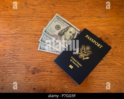 A hundred dollar bill on a table made of dark textured wood Stock Photo ...