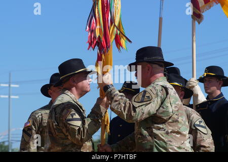 Col. John Woodward passes the brigade guidon to Maj. Gen. Paul Calvert ...