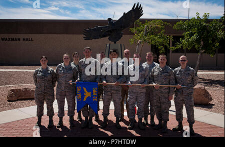Members assigned to the 32nd Weapons Squadron stand in front of the U.S ...