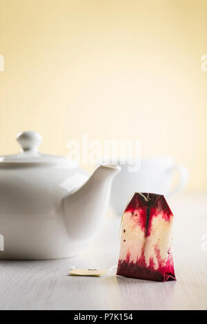A cup of tea and teapot with tea bag on wooden table Stock Photo - Alamy
