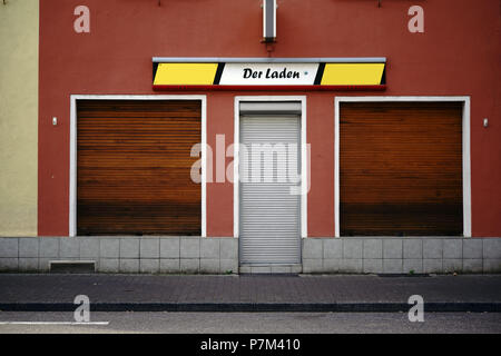 A closed shop and kiosk with lowered window shutters Stock Photo - Alamy