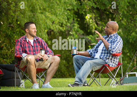 Two men friends fisherman fishing on river. Old father and son with rod ...